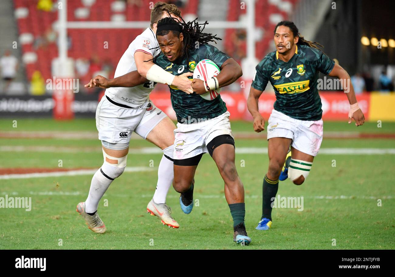 South Africa's Justin Geduld hands off USA's Stephen Tomasin during the ...