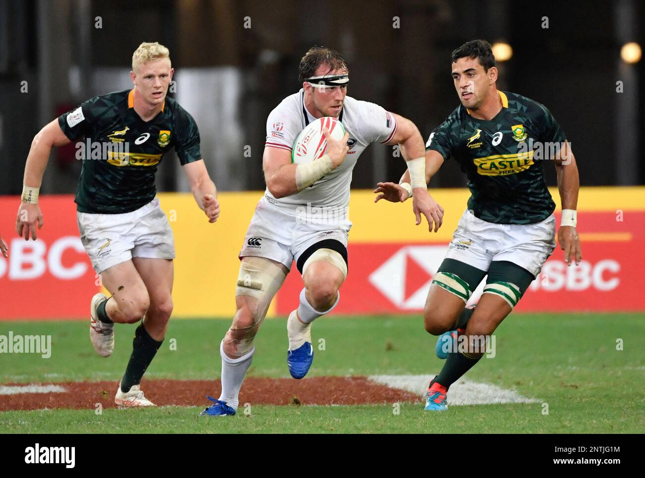 USA's Ben Pinkelman breaks past South Africa's Chris Dry and Ryan ...