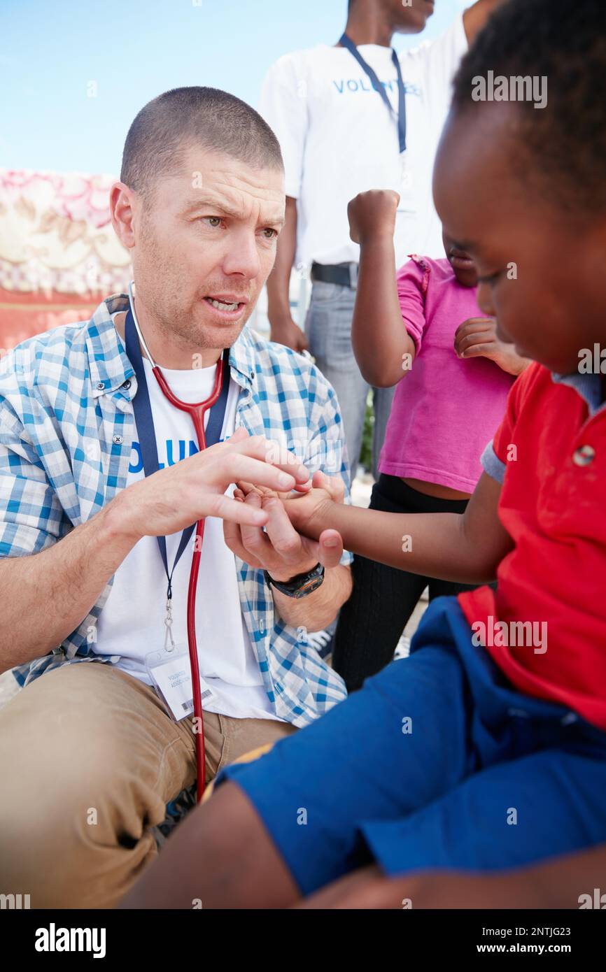 Can you feel this. a volunteer doctor giving checkups to ...