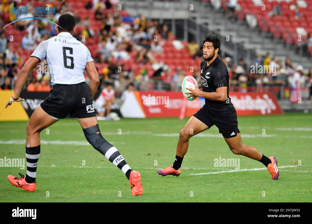 New Zealand's Regan Ware runs at Fiji's Meli Derenalagi his sides 19-5 ...