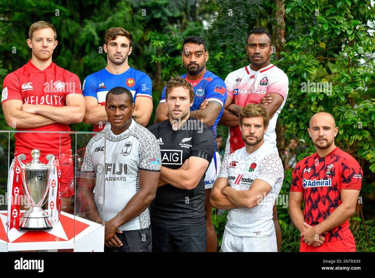 Half of the captains pose with the trophy during the HSBC Singapore ...