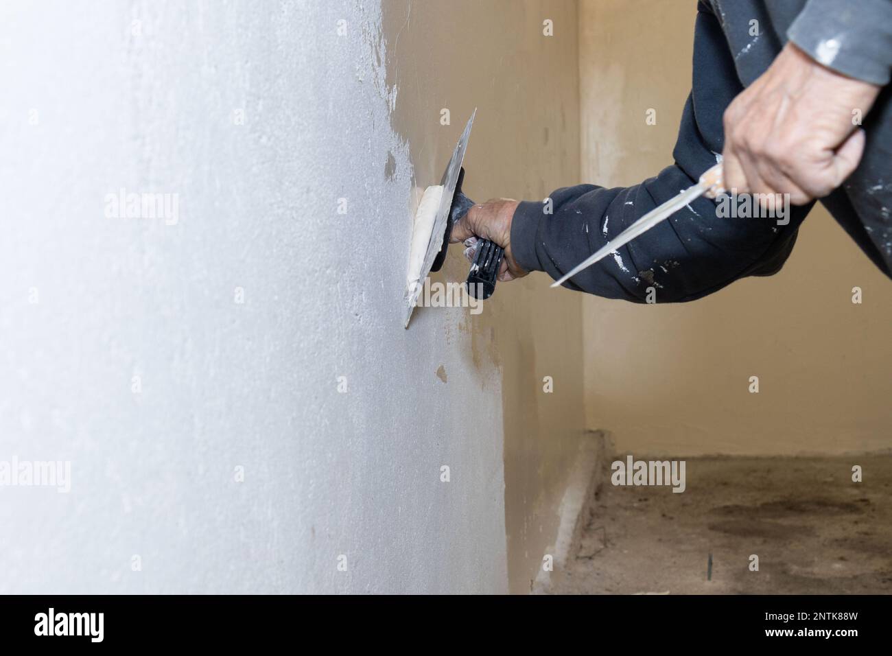 hand of worker plastering cement wall.applying grout to the wall.worker ...