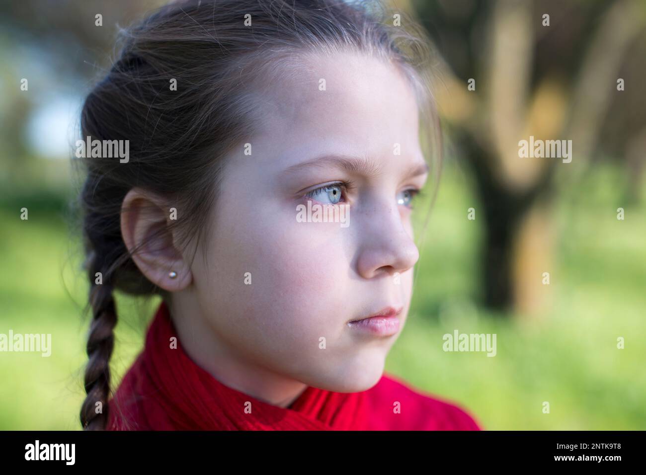 serious girl portrait with big trees outdoor Stock Photo - Alamy
