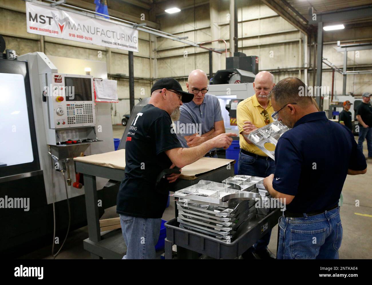 MST Manufacturing employee Rick Dye talks to people about a ...