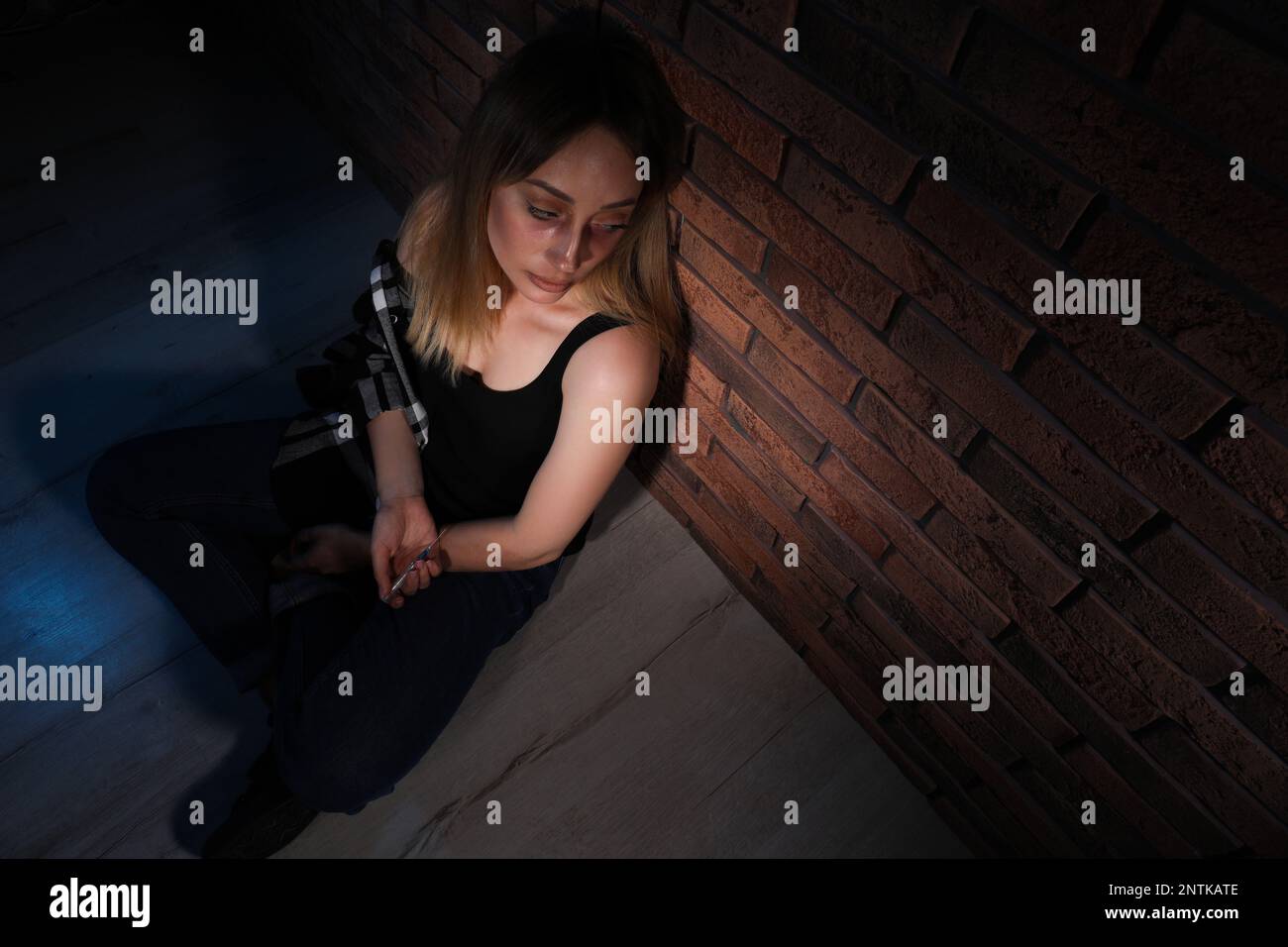 Overdosed drug addicted woman near brick wall. Space for text Stock ...