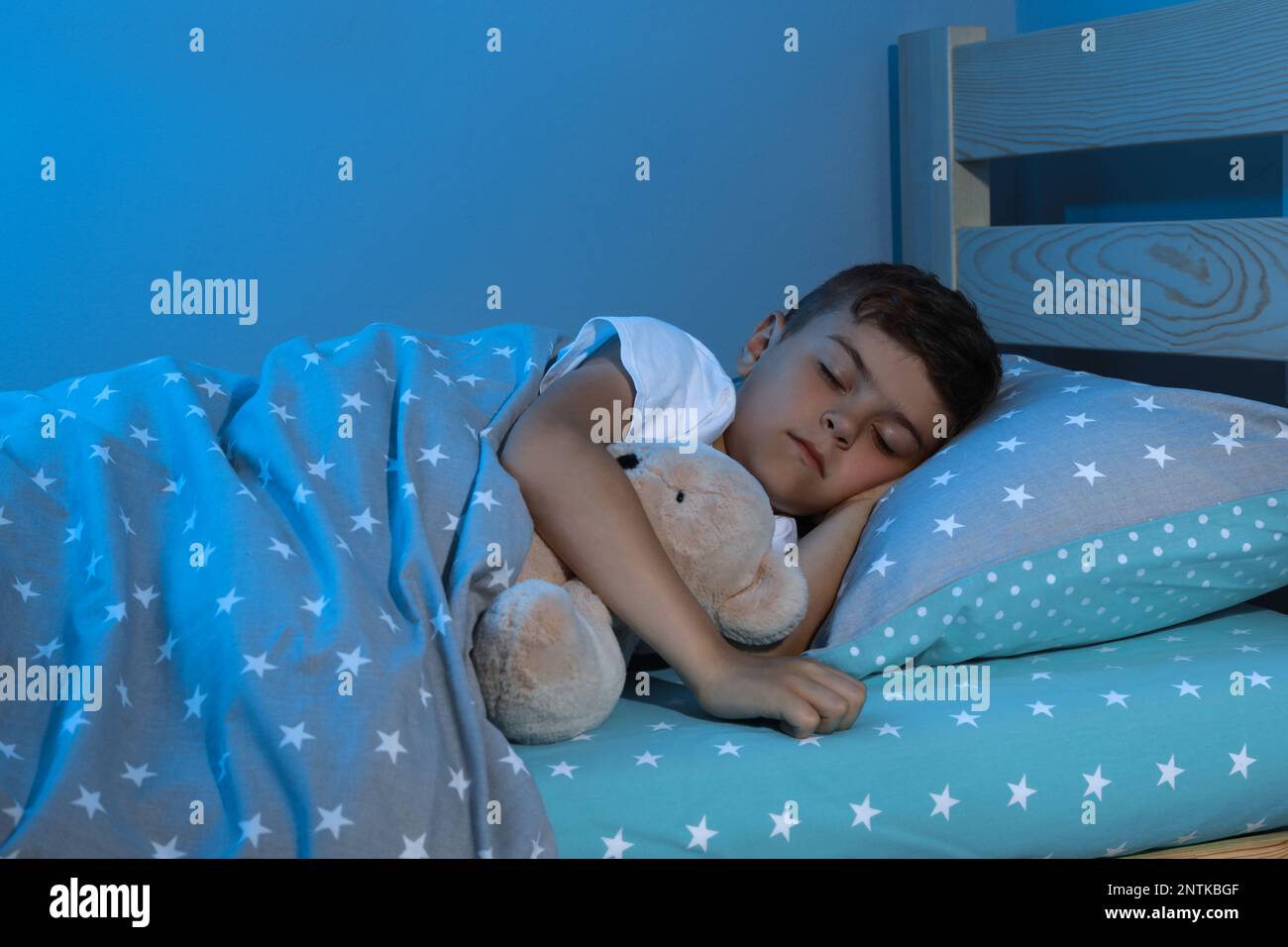Cute little boy sleeping with teddy bear at home. Bedtime Stock Photo ...