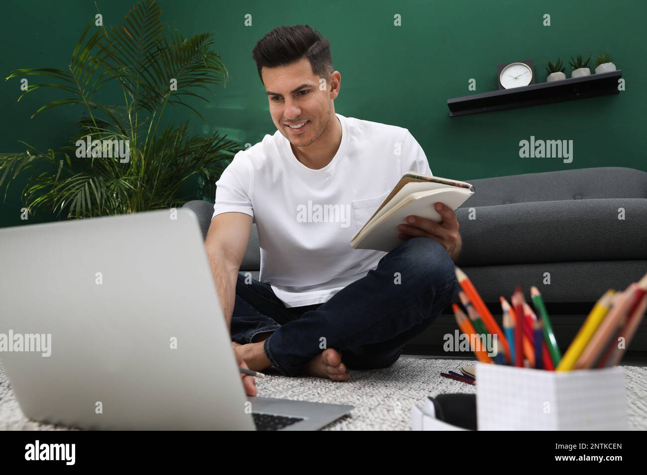 Man drawing in notebook at online lesson indoors. Distance learning ...