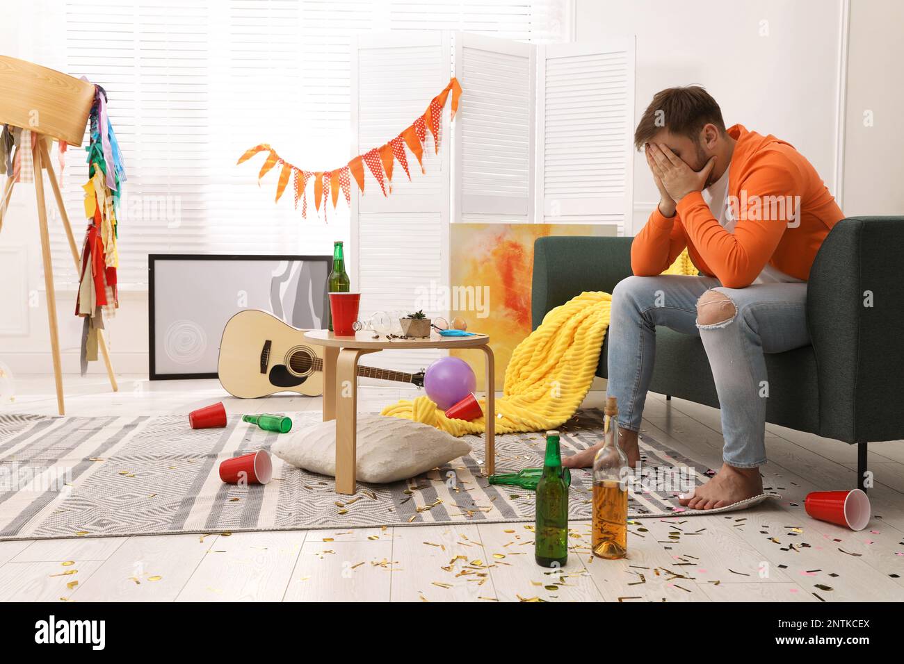 Tired drunk man on sofa in messy room after party Stock Photo - Alamy