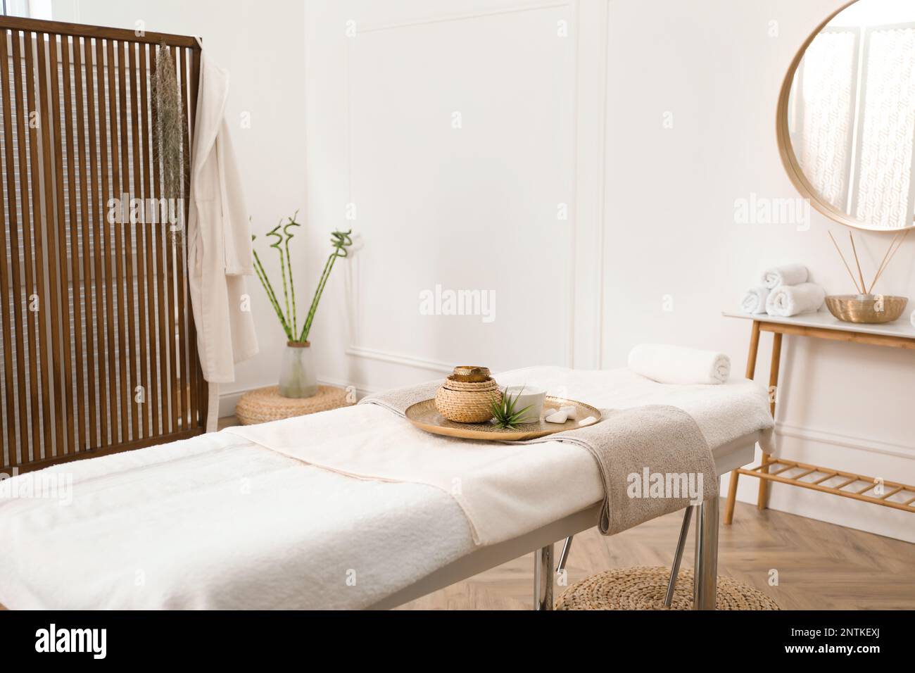 Stylish room interior with massage table in spa salon Stock Photo - Alamy