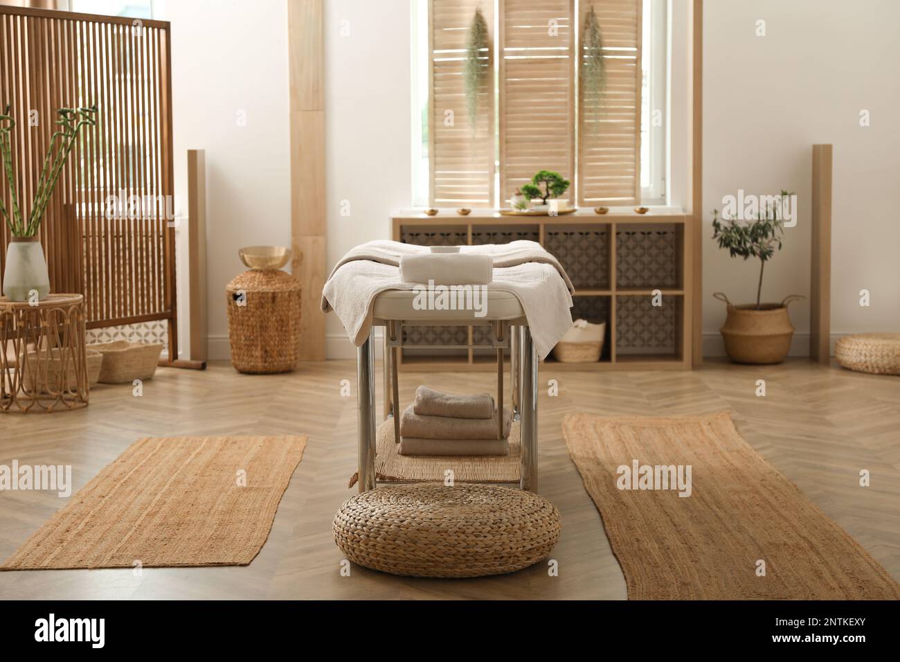 Stylish massage room interior with spa table in salon Stock Photo - Alamy