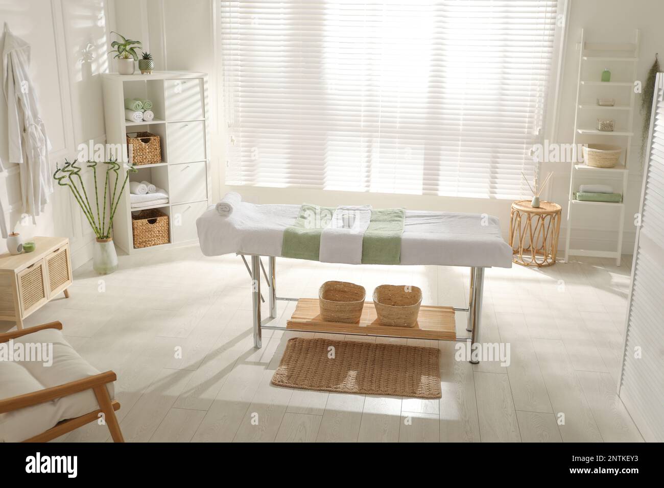 Stylish spa salon interior with massage table Stock Photo - Alamy
