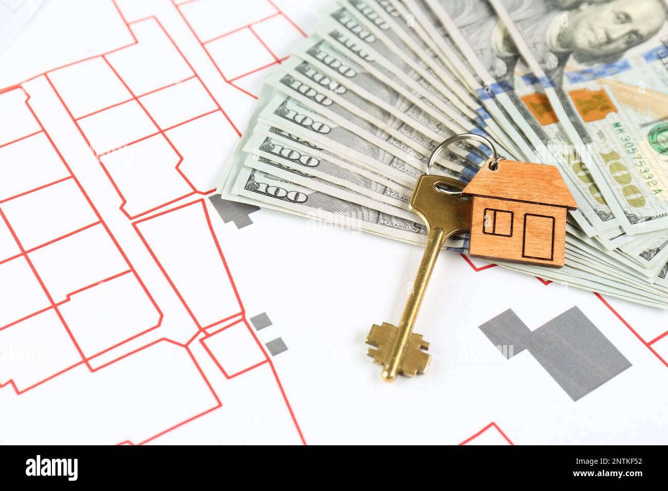 Money and house key on cadastral maps Stock Photo - Alamy