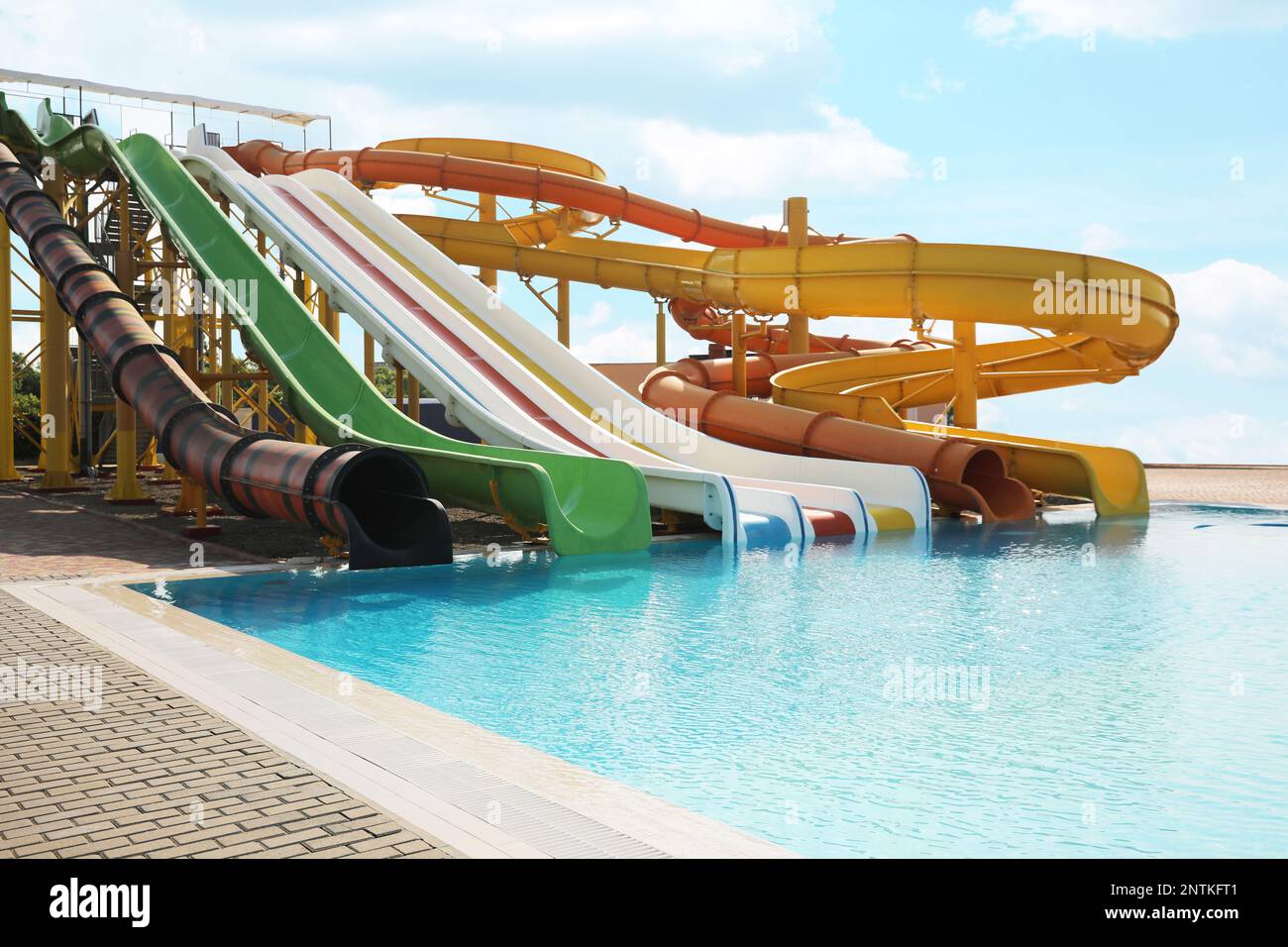 Beautiful view of water park with colorful slides and swimming pool on ...