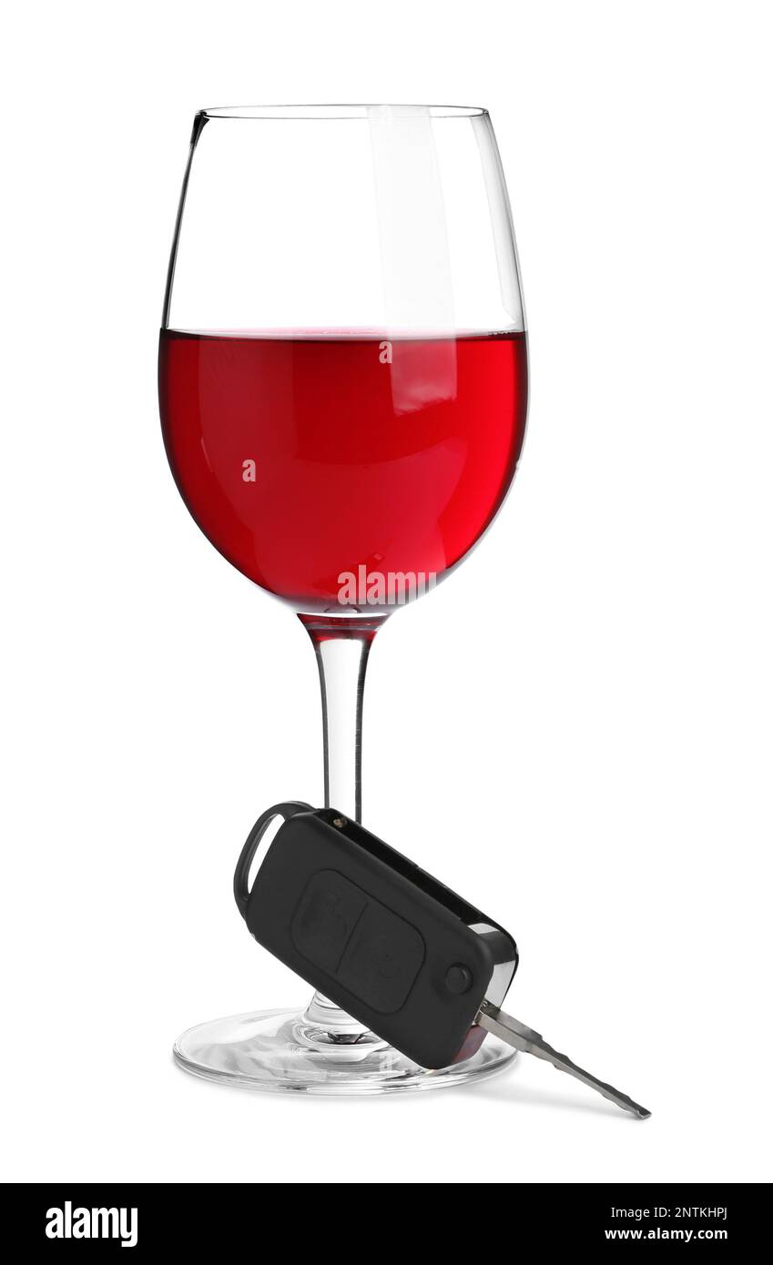 Glass of alcohol and car key on white background. Drunk driving concept ...