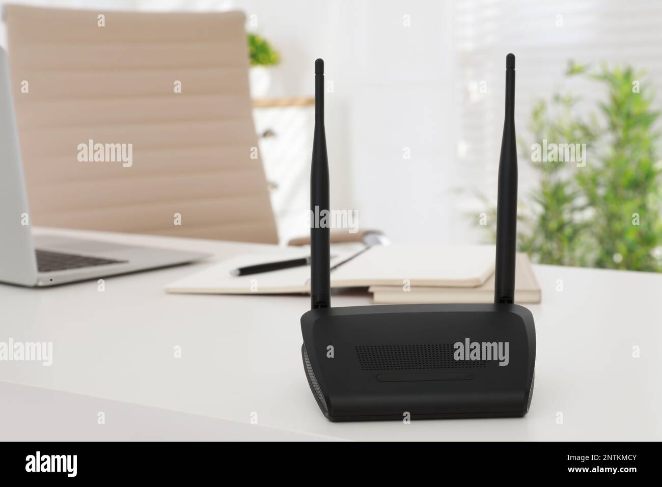 Modern wi-fi router on white table indoors Stock Photo - Alamy