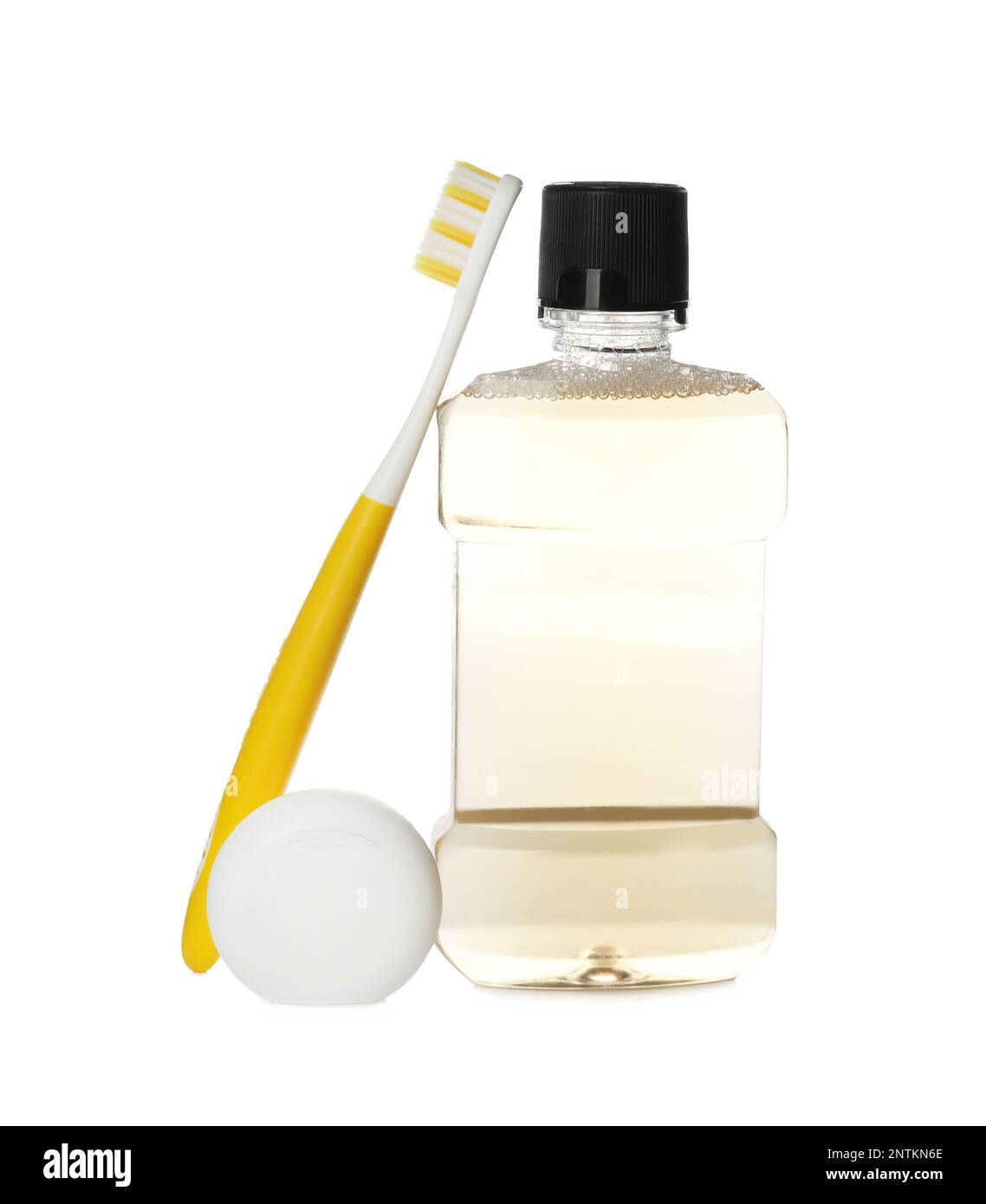 Bottle with mouthwash, dental floss and toothbrush on white background ...