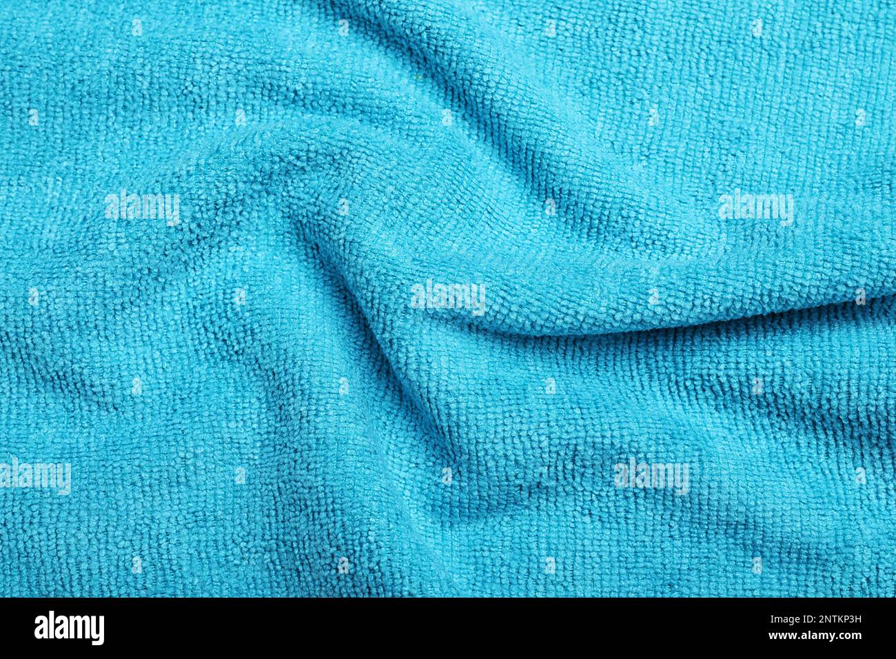 Crumpled light blue microfiber cloth as background, closeup Stock Photo ...