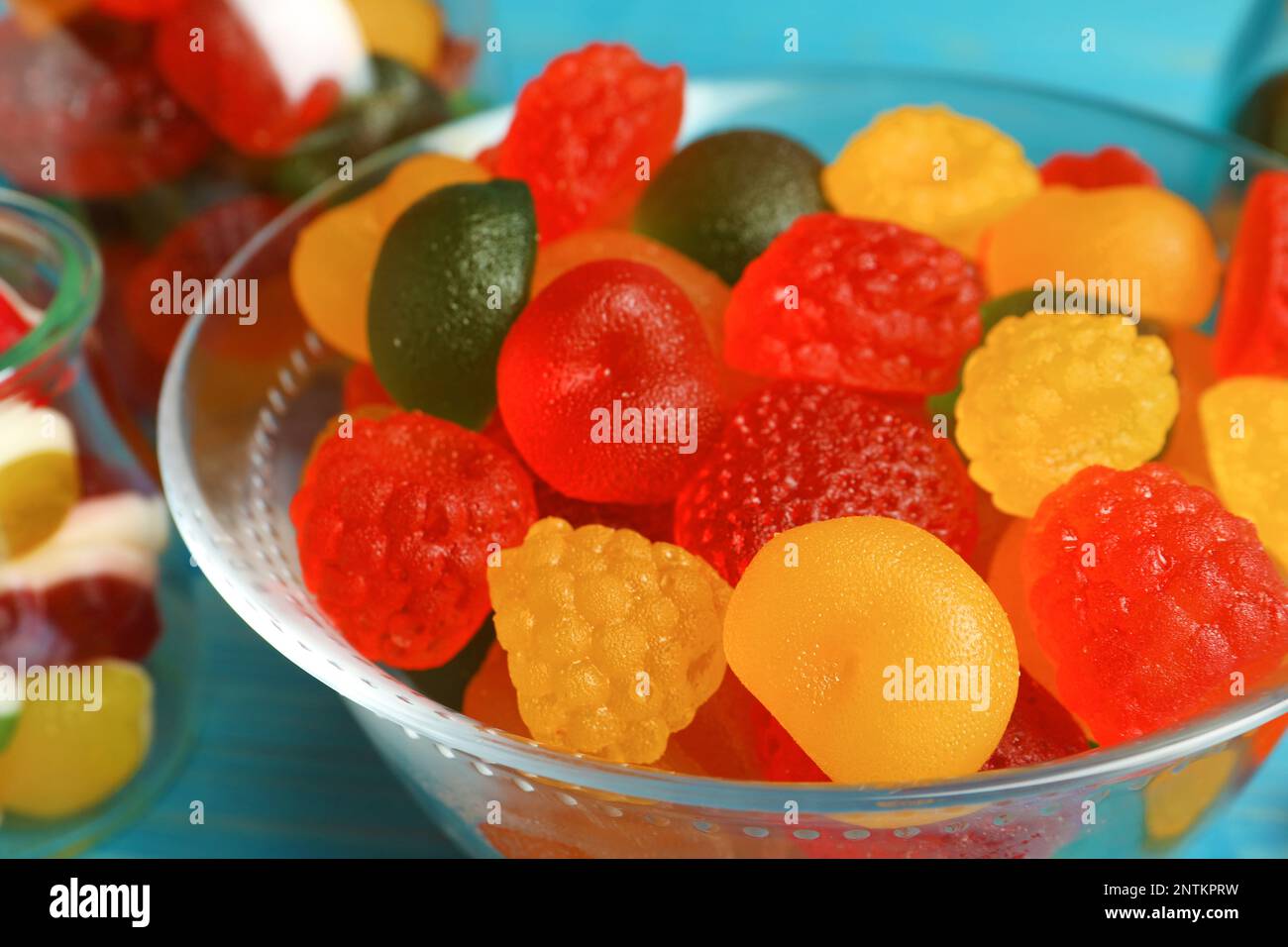 Delicious gummy fruit shaped candies in glass bowl, closeup Stock Photo ...