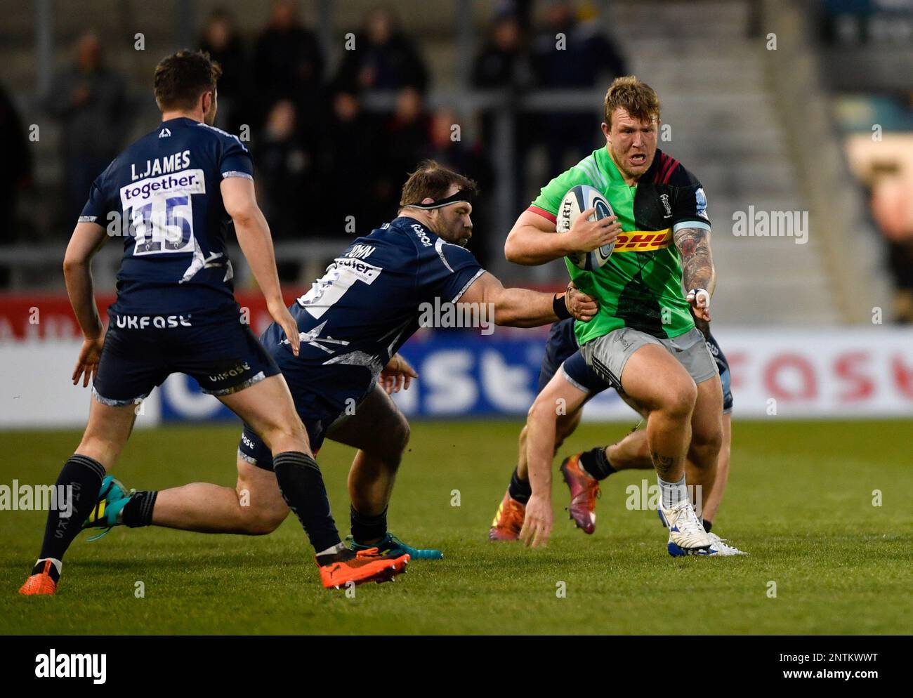 Harlequins No.8 Alex Dombrandt makes a break past Sale Sharks prop ...