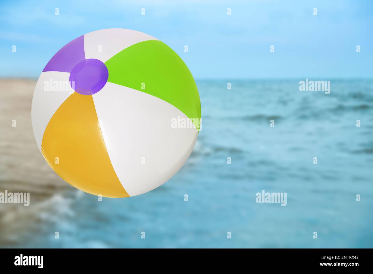 Colorful inflatable beach ball and seascape on background Stock Photo ...