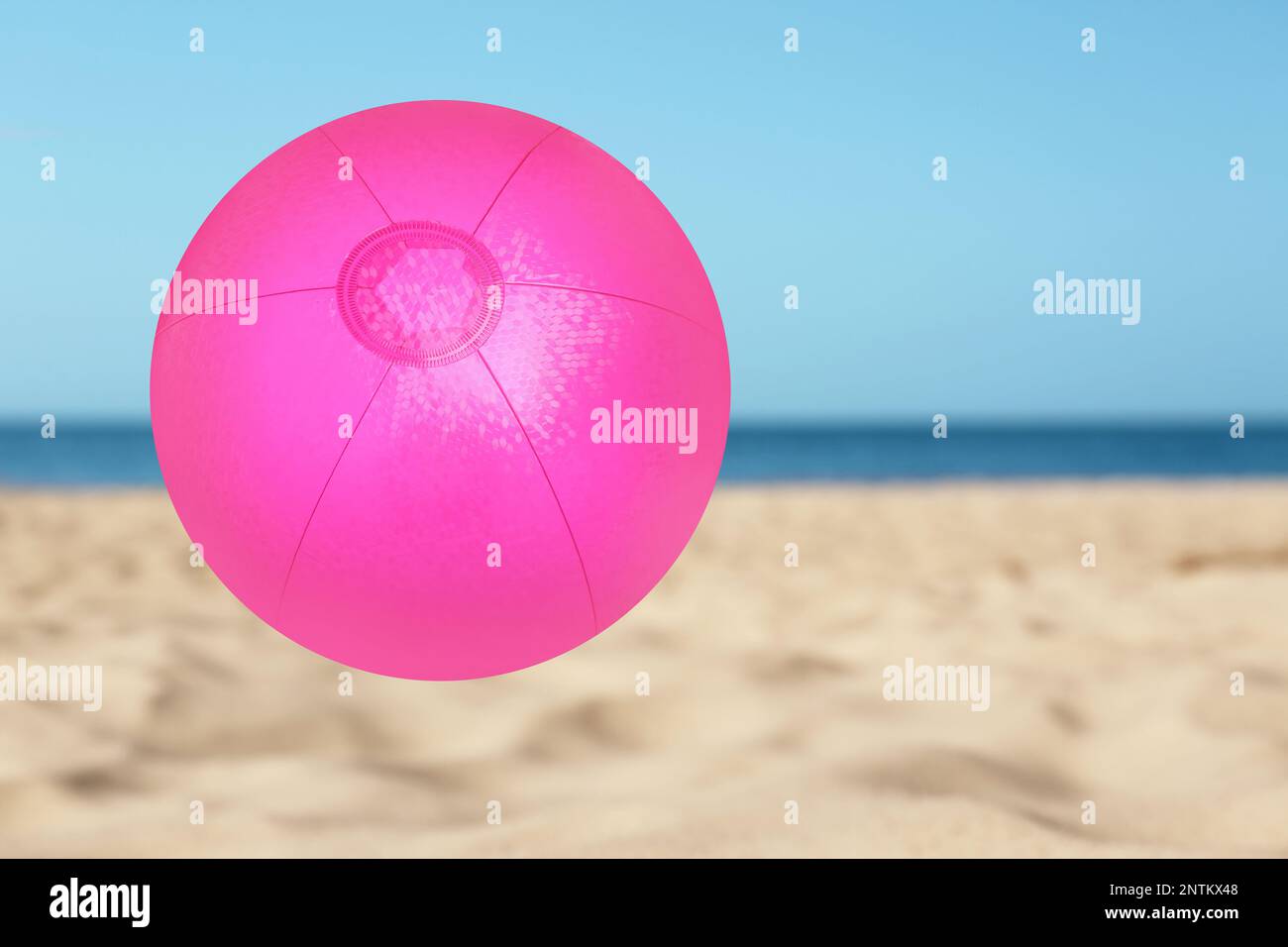 Pink inflatable beach ball and seascape on background Stock Photo - Alamy