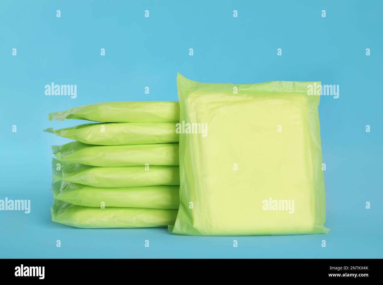 Stack of menstrual pads on light blue background Stock Photo - Alamy