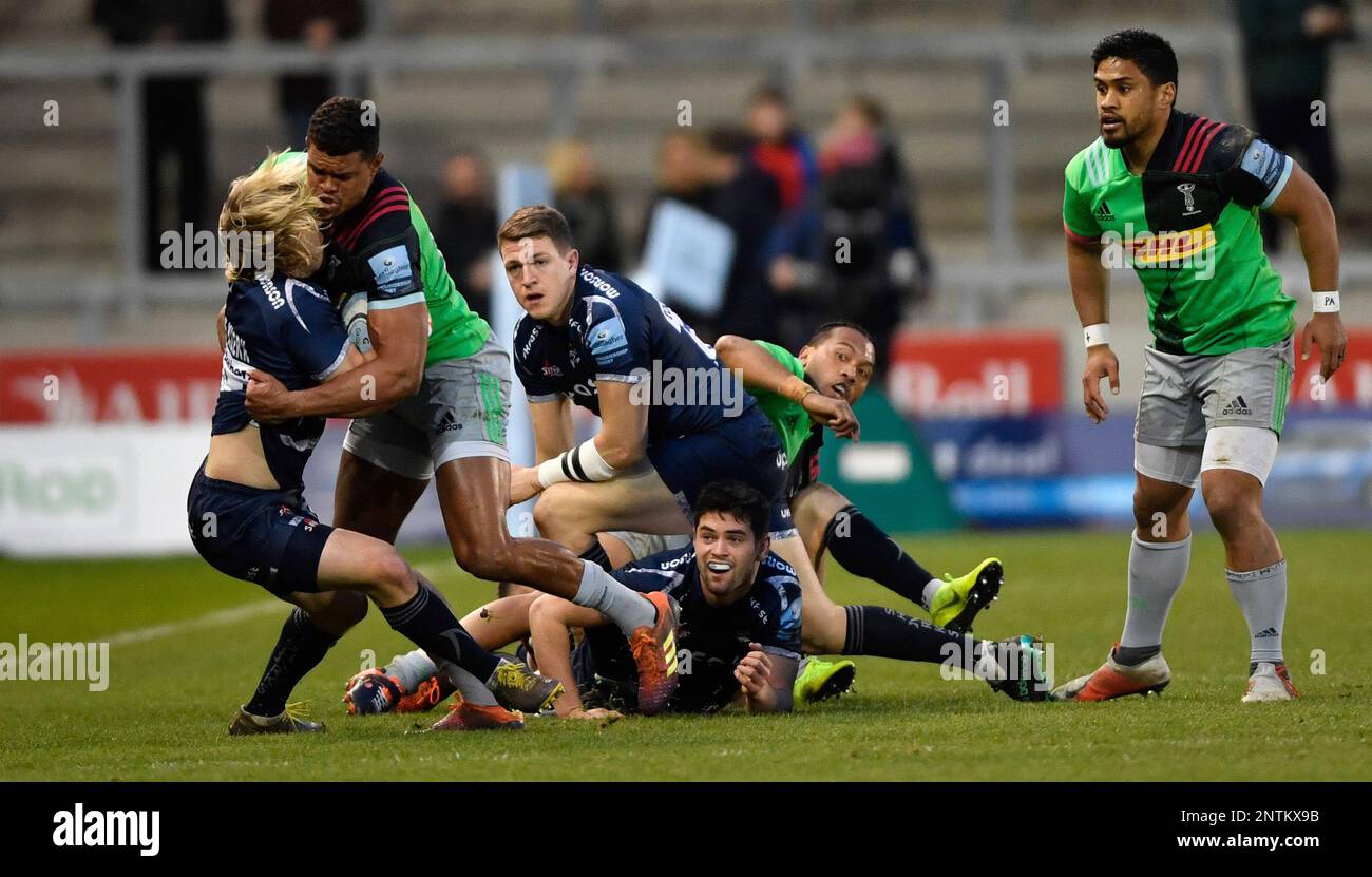 Harlequins wing Nathan Earle tackles Sale Sharks scrum-half Faf De ...