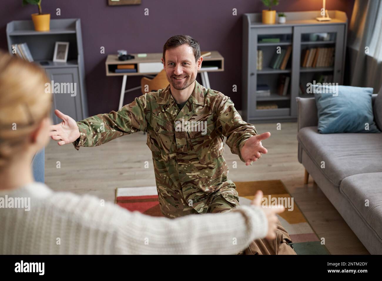 Portrait of happy military dad coming back home and embracing daughter ...