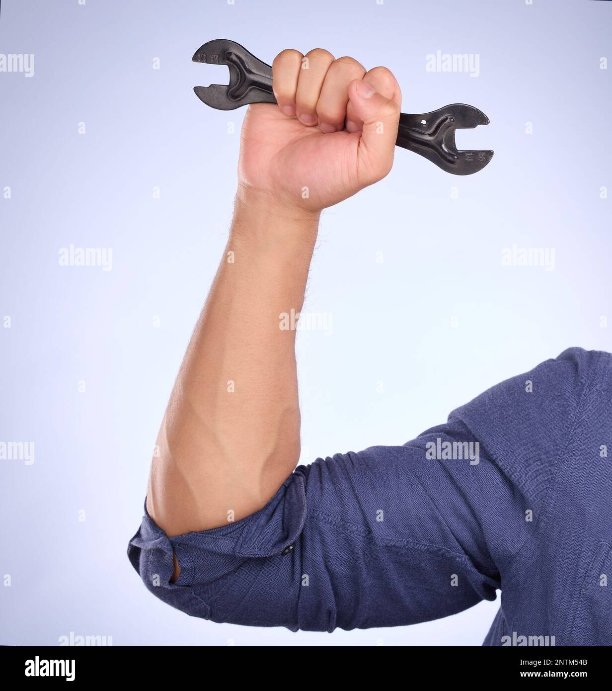 Man hand holding wrench isolated on studio background for repair ...