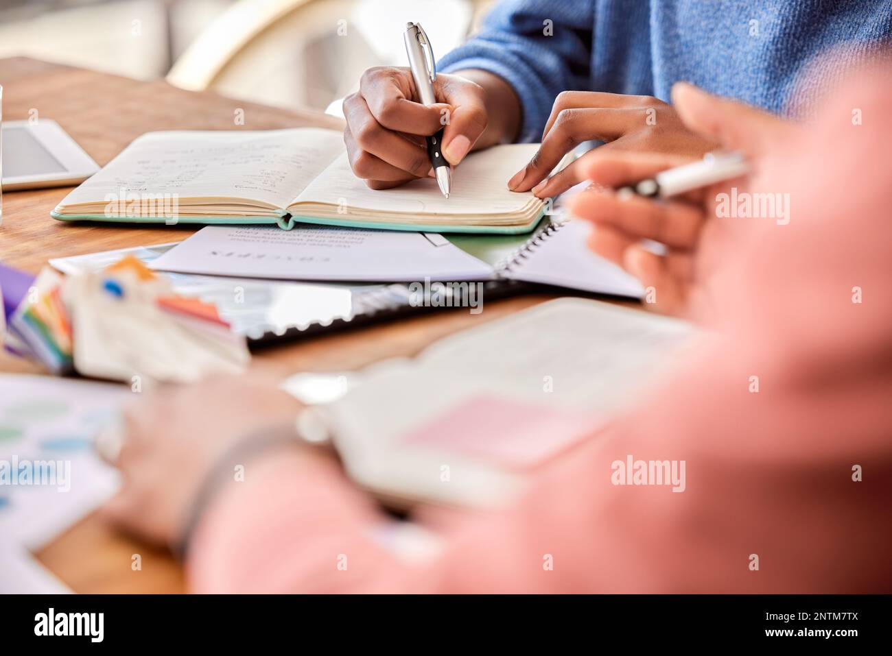 Meeting, planning and team writing notes while in discussion on a ...