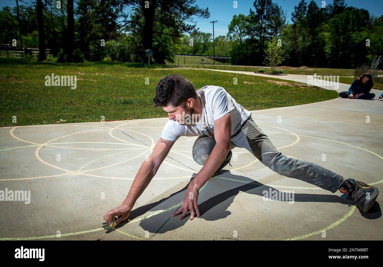 Artist Josh "Lakey" Hinson uses his body as compasses while doing a ...
