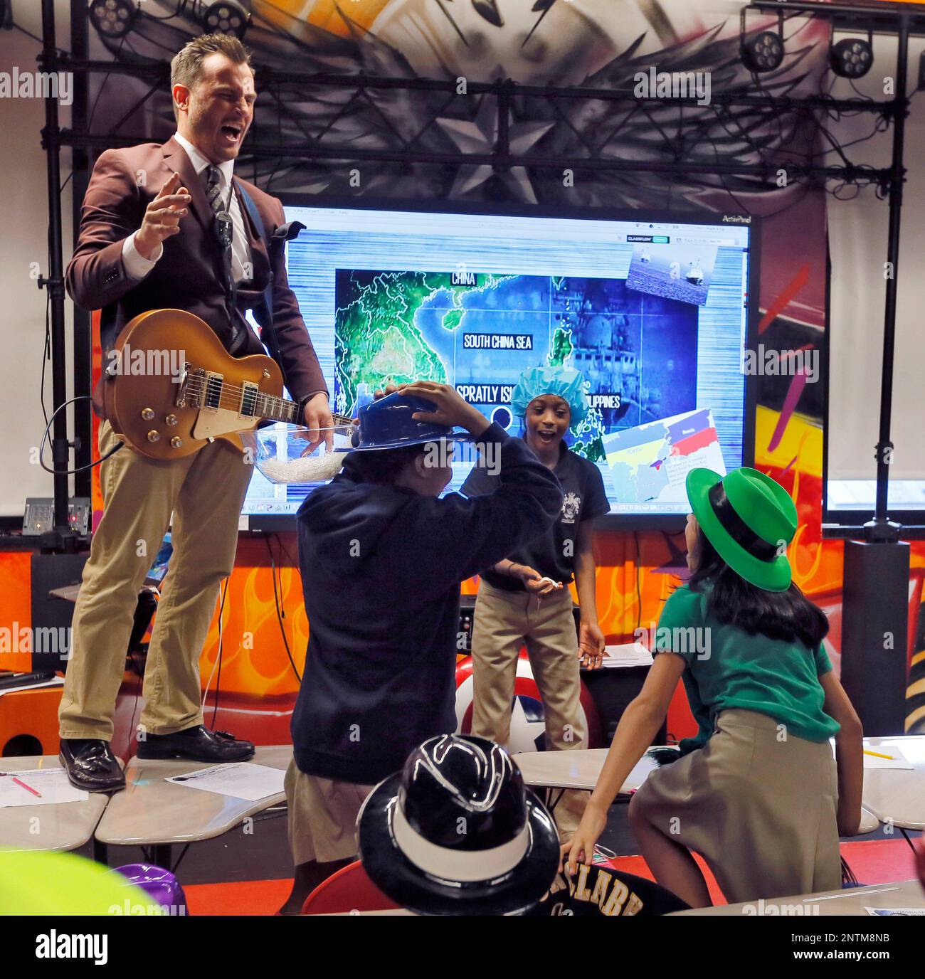 Wade King uses an electric guitar in teaching his fifth grade current ...