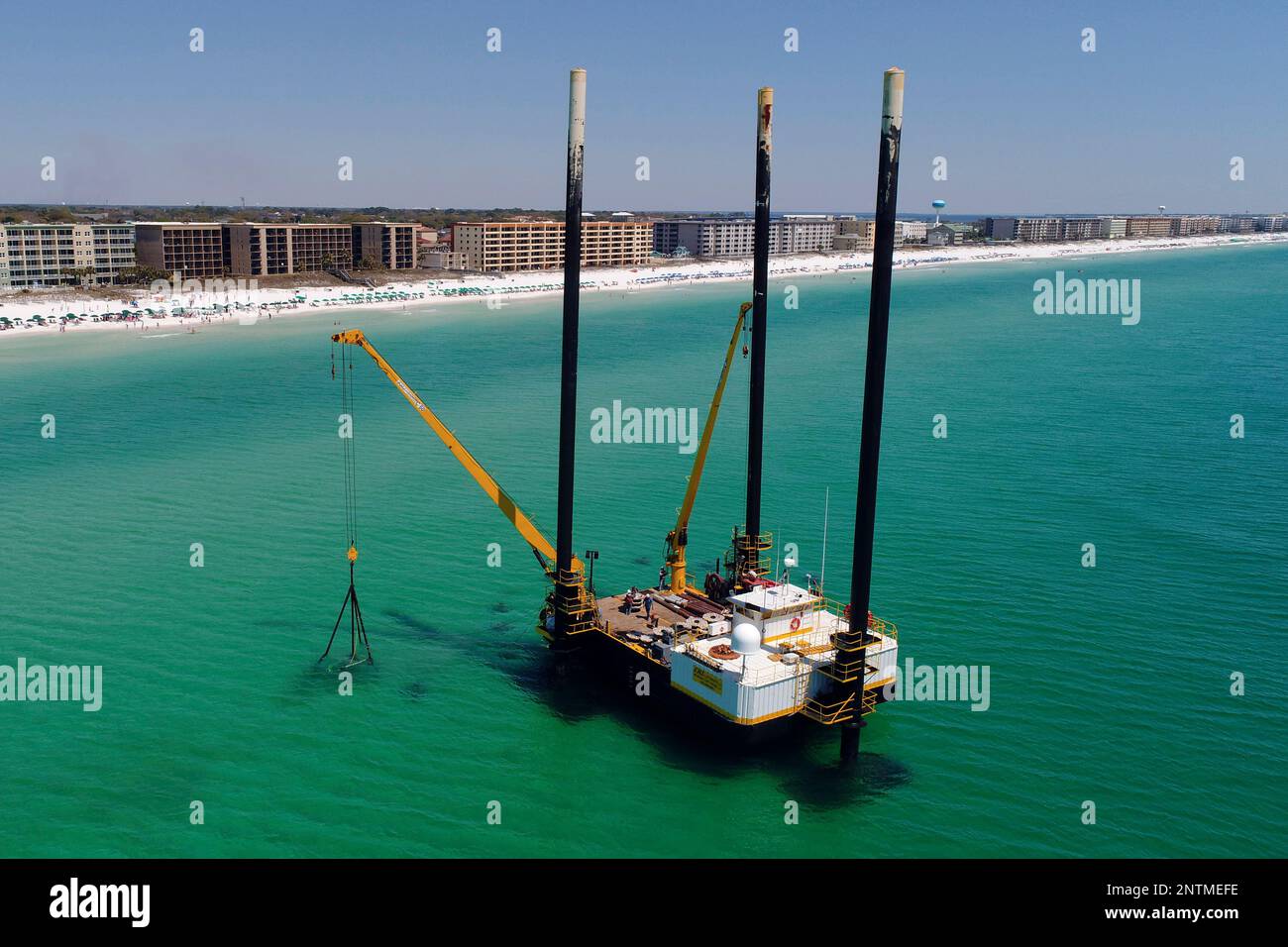 A marine contracting crew installs an artificial snorkeling reef in the ...