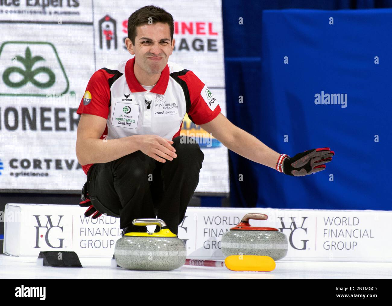 Switzerland skip Peter de Cruz grimaces as he gets ready to deliver a ...