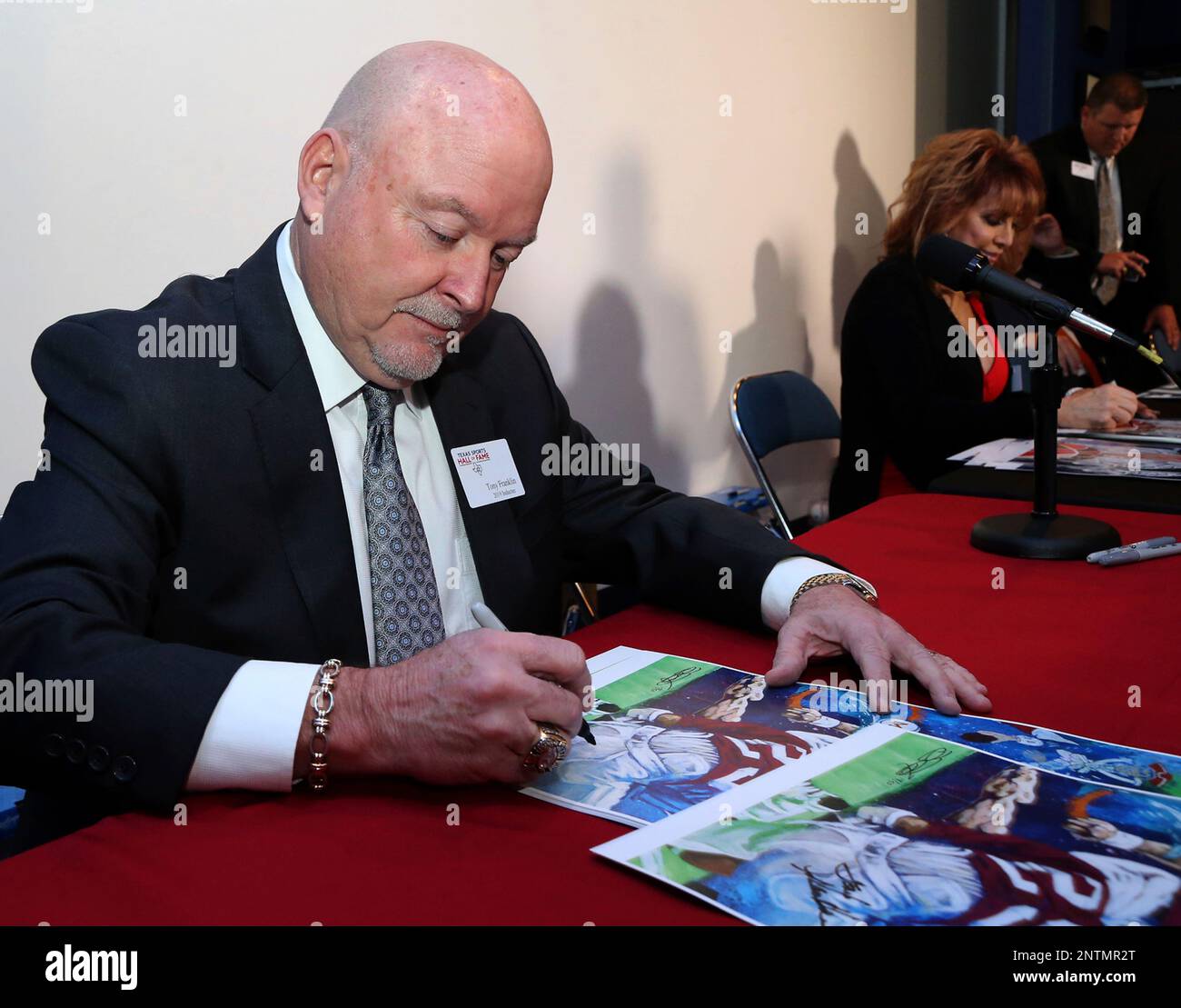 Former Texas A&M and NFL kicker Tony Franklin signs a poster before ...