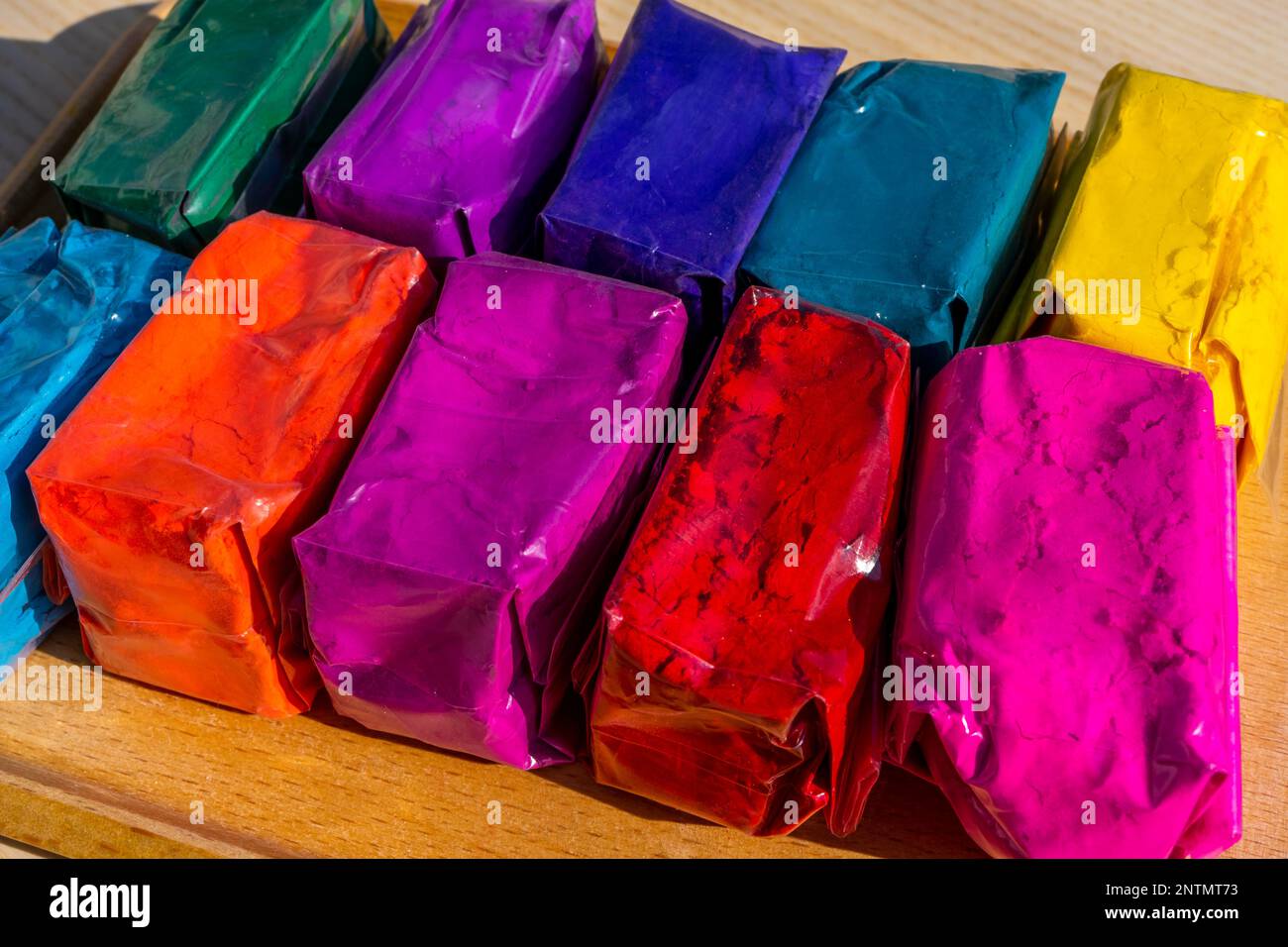 Dry colours Gulal packed in plastic pack placed at market shop for sale ...