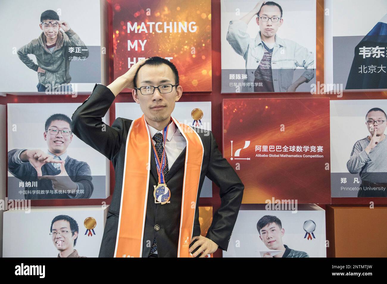 Gu Chenlin from École Normale Supérieure in Paris mocks his own portrait in front of a billboard ...