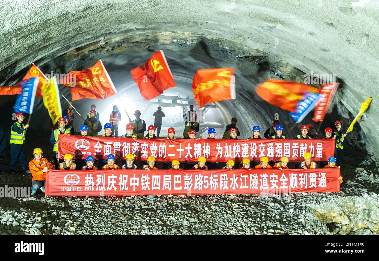 CHONGQING, CHINA - FEBRUARY 27, 2023 - Workers raise flags to celebrate ...
