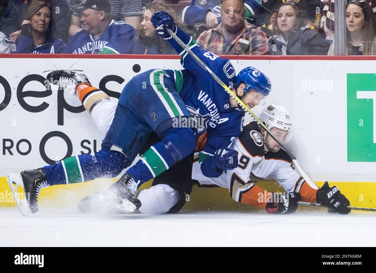 Vancouver Canucks' Alexander Edler, front, of Sweden, checks Anaheim ...