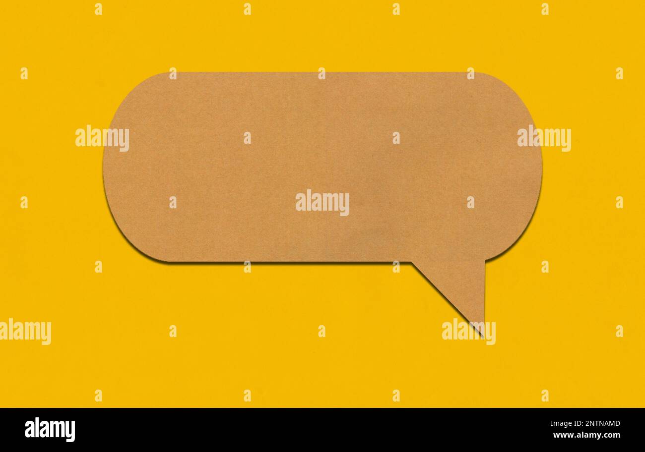 Brown paper speech bubble on yellow paper background. Paper blank of ...