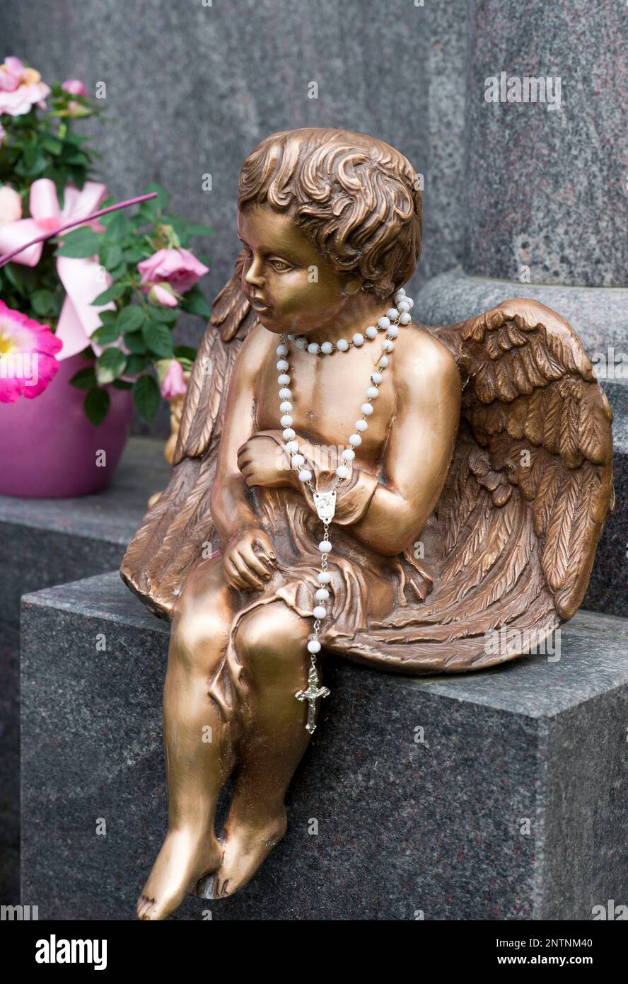 Golden girl guardian angel with long cross necklace Stock Photo - Alamy