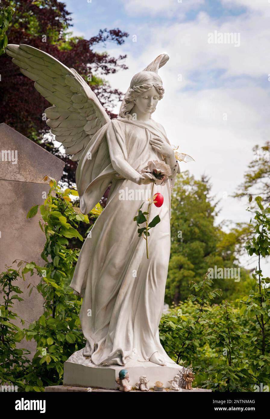 Large marble angel with red Easter egg Stock Photo - Alamy
