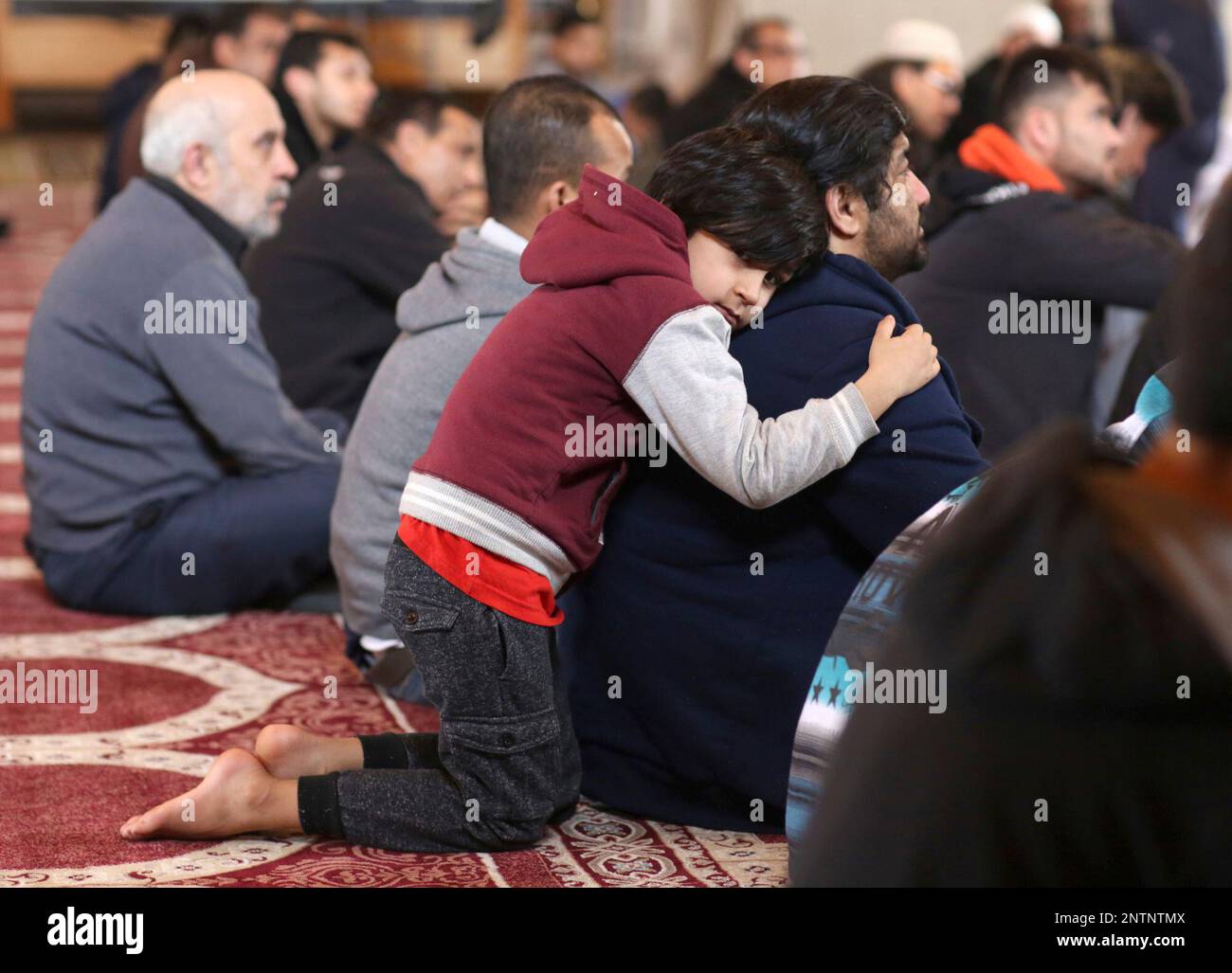 Iman Tajak of Scranton hugs his father, Mohammad Tajak, at the Islamic ...