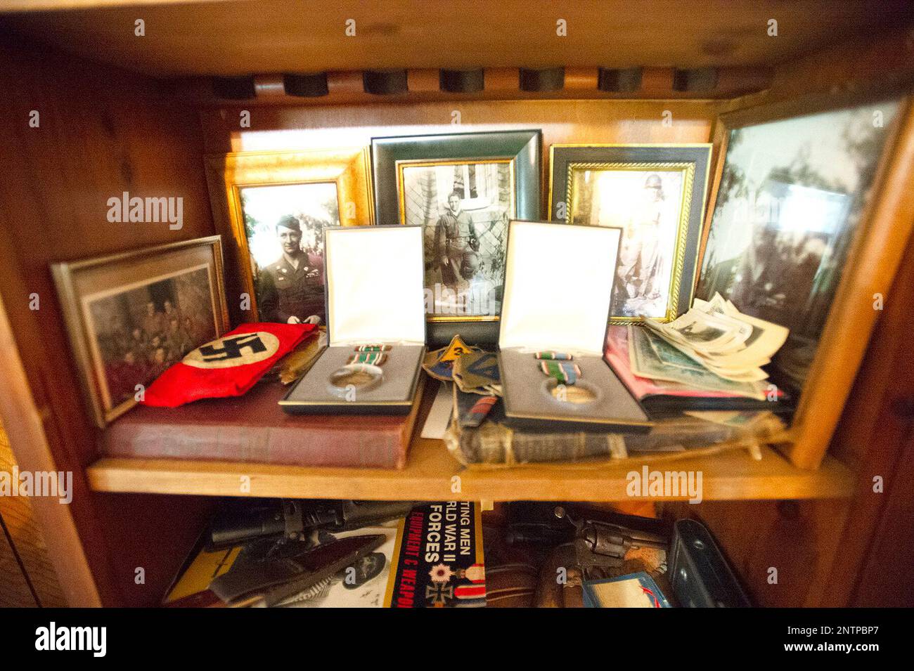 A collection of photos, medals, service patches and a Nazi arm band ...