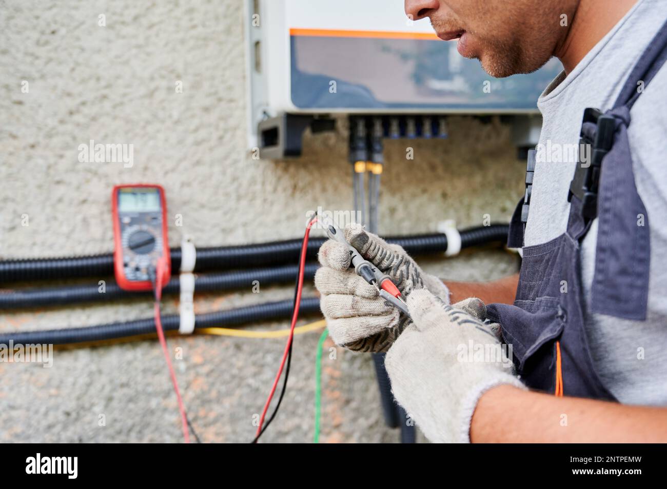 Man electrician installing solar panel system. Cropped view of ...