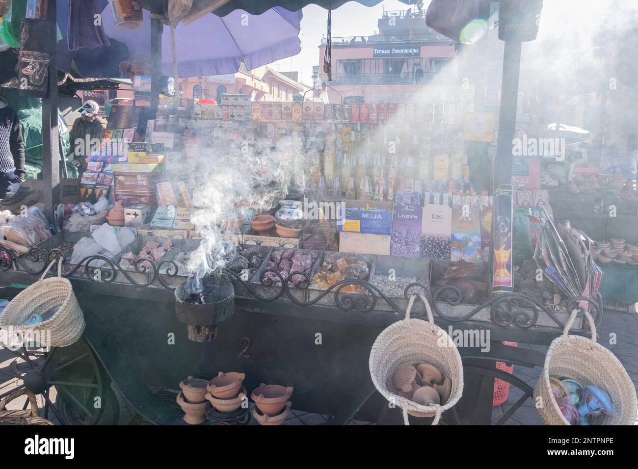 Carriage of incense for sale shrouded in smoke in a souk in the Medina ...