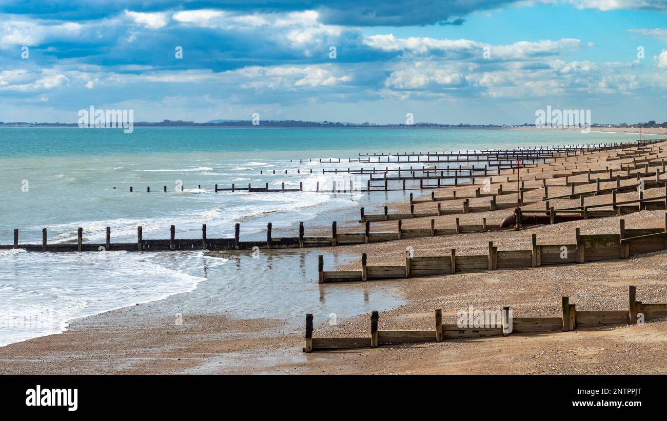 A view looking west down Bognor Regis beach in West Sussex, UK. Wooden ...