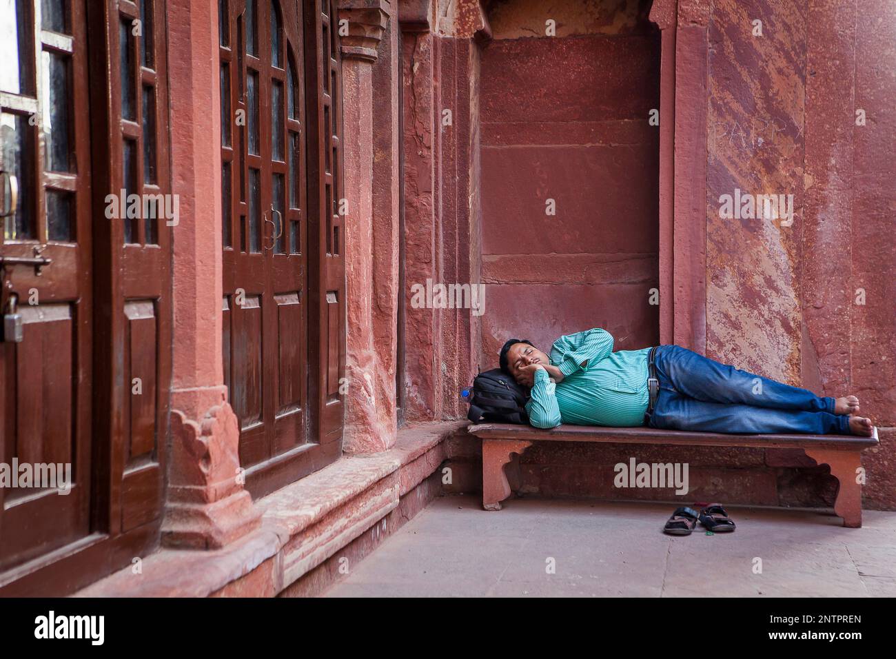 Exhausted tourist. Visitor sleeping in main gate of Agra Fort, UNESCO ...