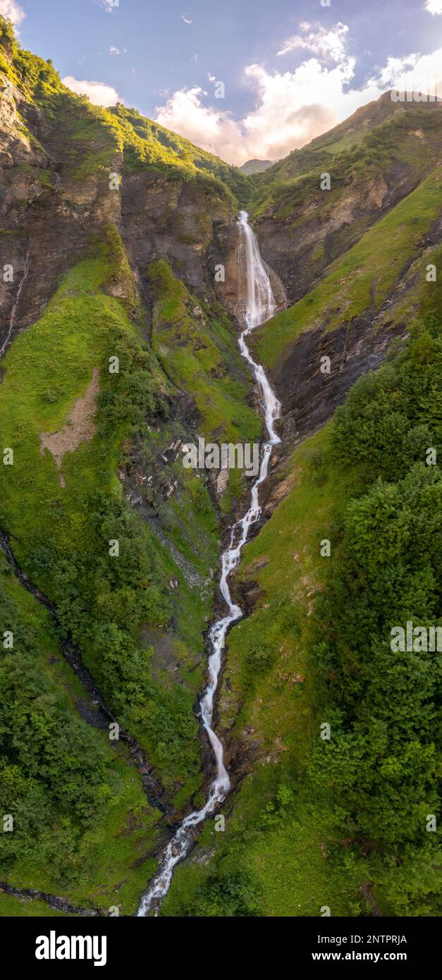 A waterfall flowing down a steep mountain Stock Photo - Alamy