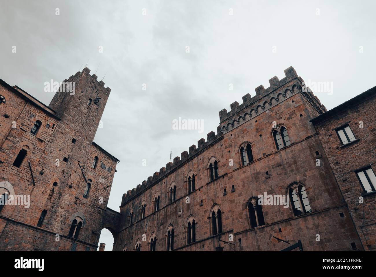 Medieval palace with turret in the central square of San Gimignano with ...